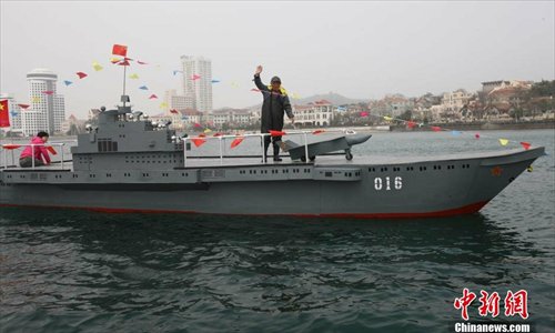 Carried away: Qingdao man sets sail on replica aircraft carrier ...