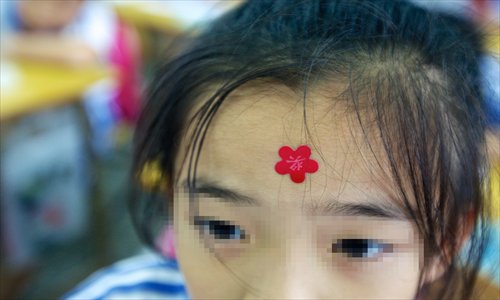 New teacher told to stop stamping faces of her good, bad students ...