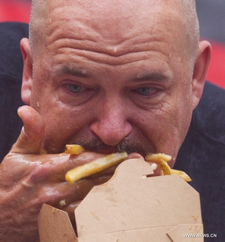 Man wins title in eating contest after gobbling 48 boxes of poutine ...