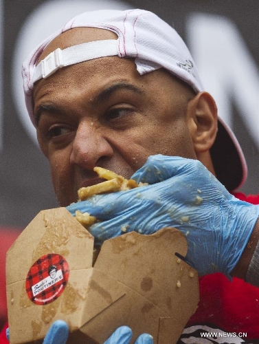 Man wins title in eating contest after gobbling 48 boxes of poutine ...