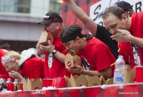 Man wins title in eating contest after gobbling 48 boxes of poutine ...