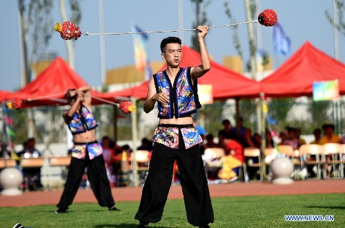 Athletes perform traditional sport event during Ethnic Games - Global Times
