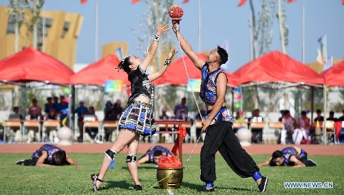 Athletes perform traditional sport event during Ethnic Games - Global Times
