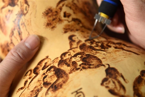 Pyrograph calabash shown best wishes for Chinese Year of Monkey ...