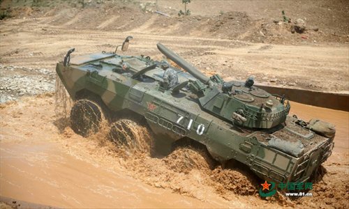 Soldiers driving eight-wheeled infantry fighting vehicles in combat ...