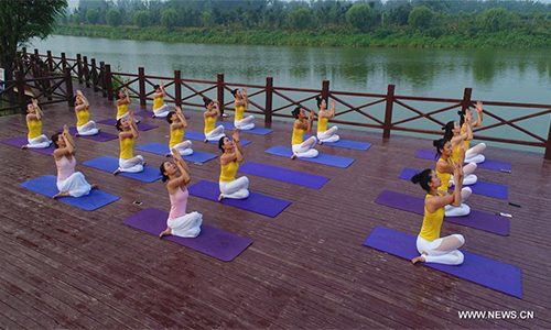 Women practice yoga in central China's Henan - Global Times