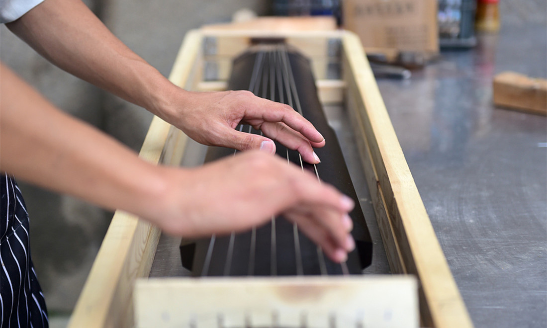 Plucky craftsman helps ancient Chinese instrument resonate with new ...