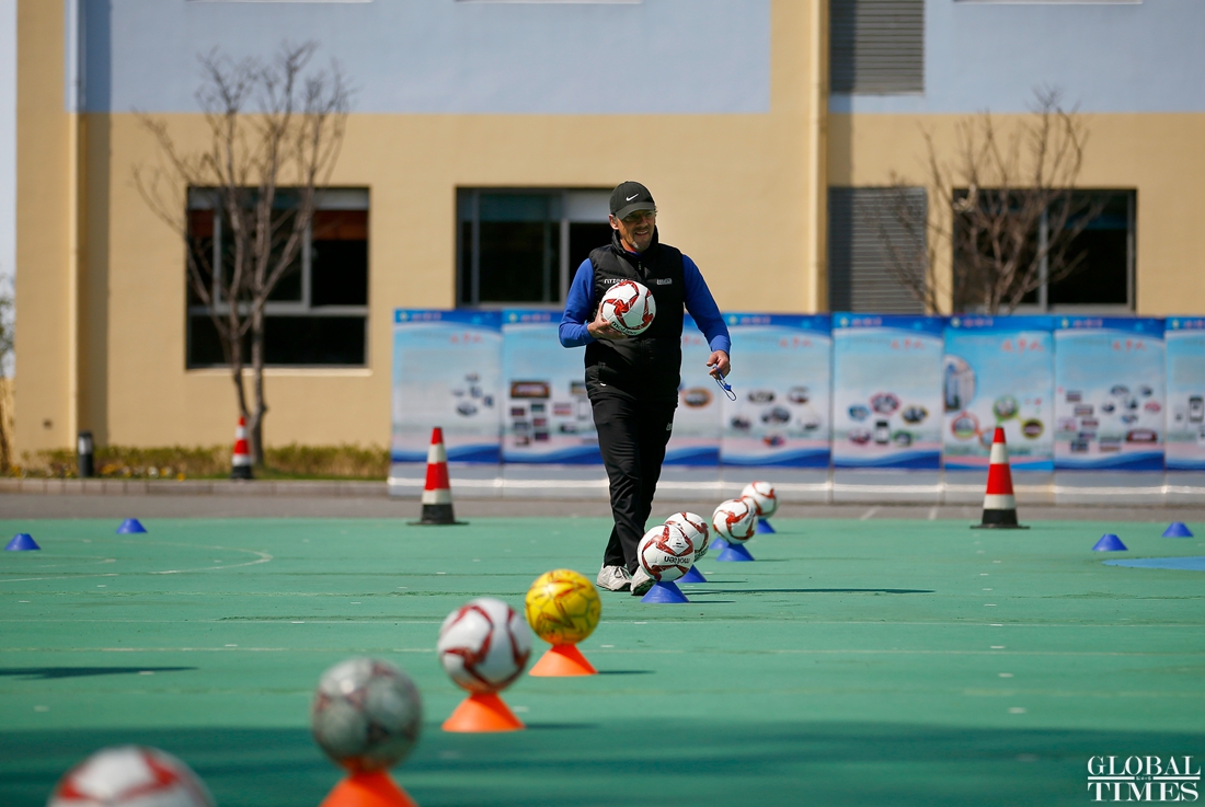Foreign coaches teach football classes to students at schools in ...