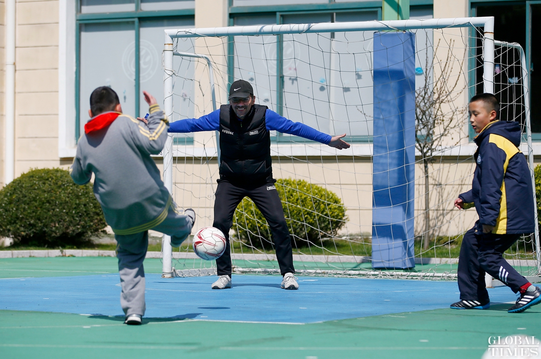 Foreign coaches teach football classes to students at schools in ...