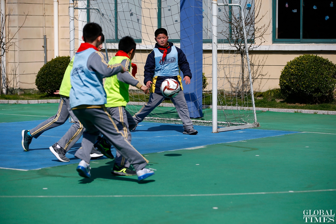 Foreign coaches teach football classes to students at schools in ...