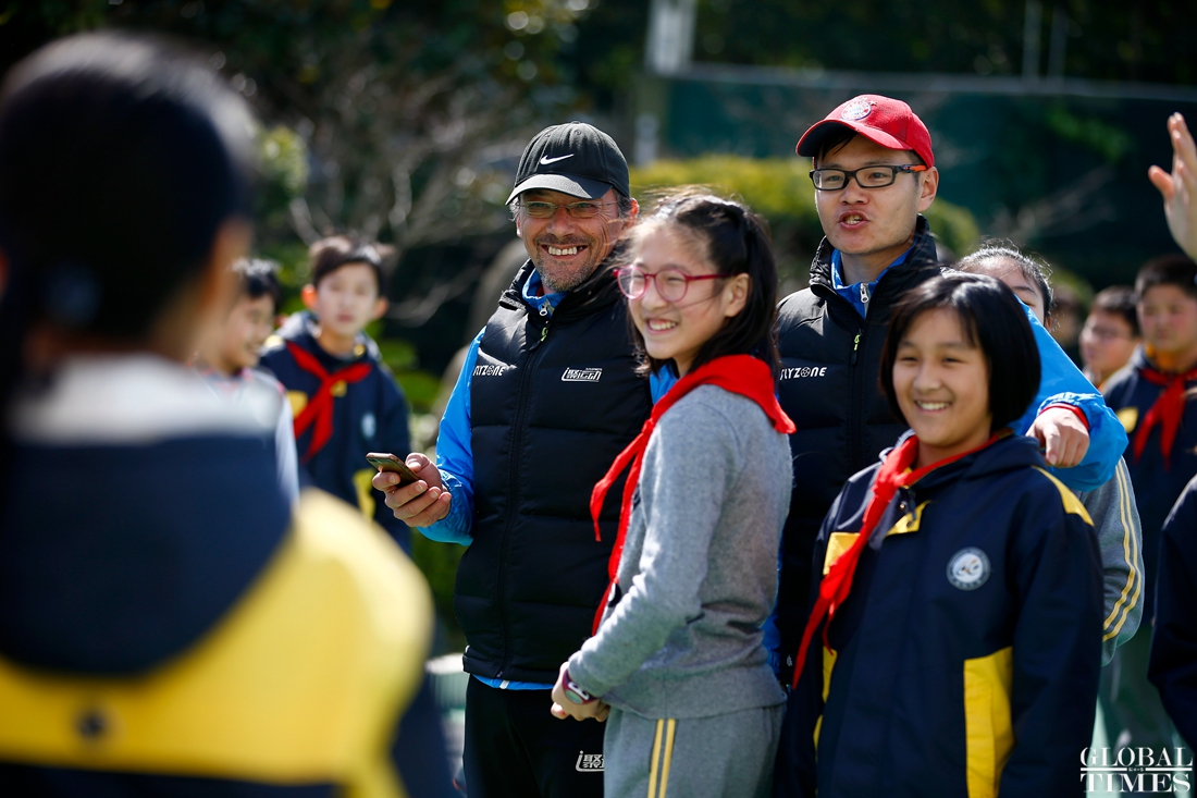 Foreign coaches teach football classes to students at schools in ...
