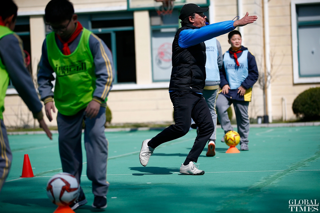 Foreign coaches teach football classes to students at schools in ...
