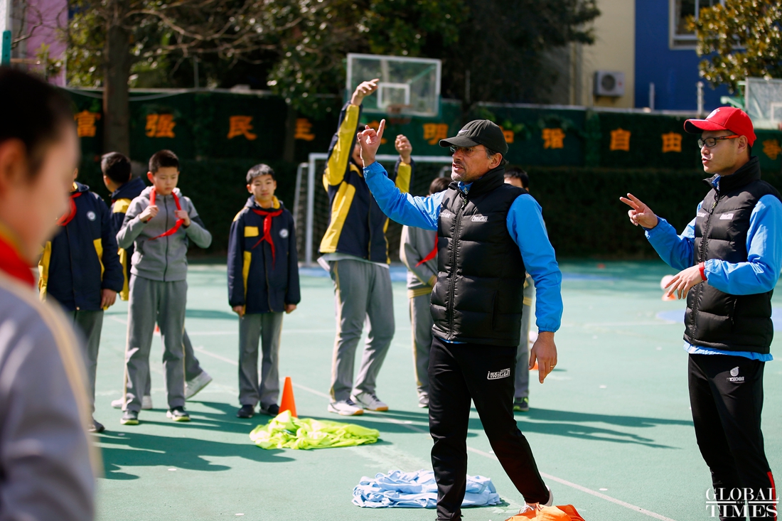 Foreign coaches teach football classes to students at schools in ...