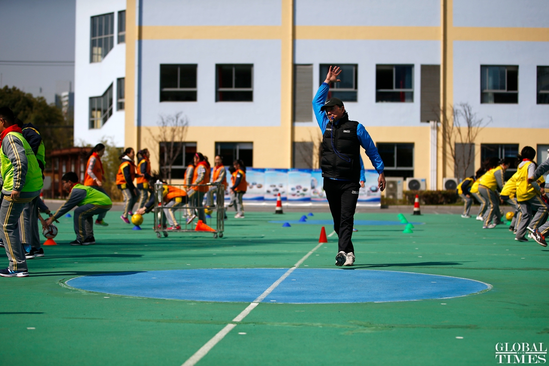 Foreign coaches teach football classes to students at schools in ...