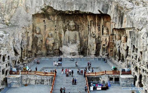 People visit Longmen Grottoes scenic area in Luoyang, C China's Henan ...