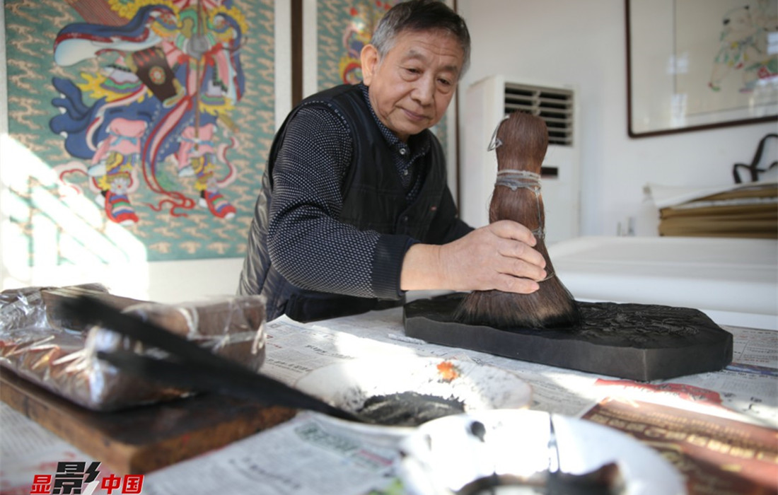 Chinese craftsman producing unique woodcut new year pictures for 60 ...