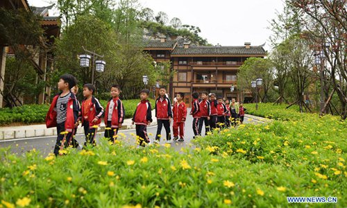 Poverty-stricken families in China's Guizhou moves into new houses with ...