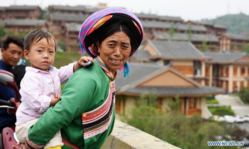 Poverty-stricken families in China's Guizhou moves into new houses with ...