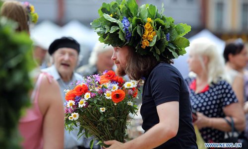 People visit Midsummer festival Ligo market in Riga, Latvia - Global Times