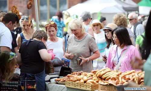 People visit Midsummer festival Ligo market in Riga, Latvia - Global Times