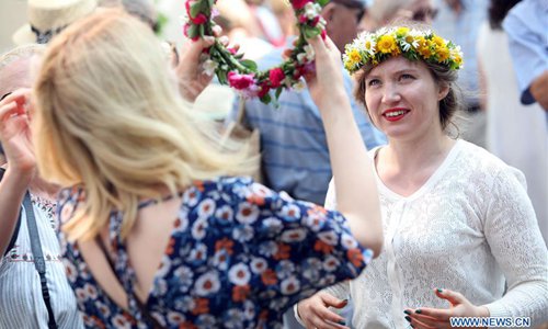 People visit Midsummer festival Ligo market in Riga, Latvia - Global Times