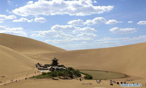 Tourists visit Mingsha Mountain and Crescent Spring scenic area in ...