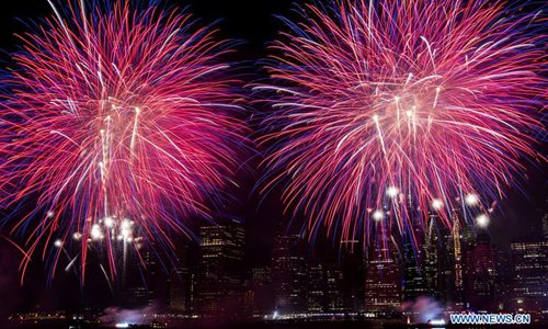 People watch fireworks exploding during U.S. Independence Day ...