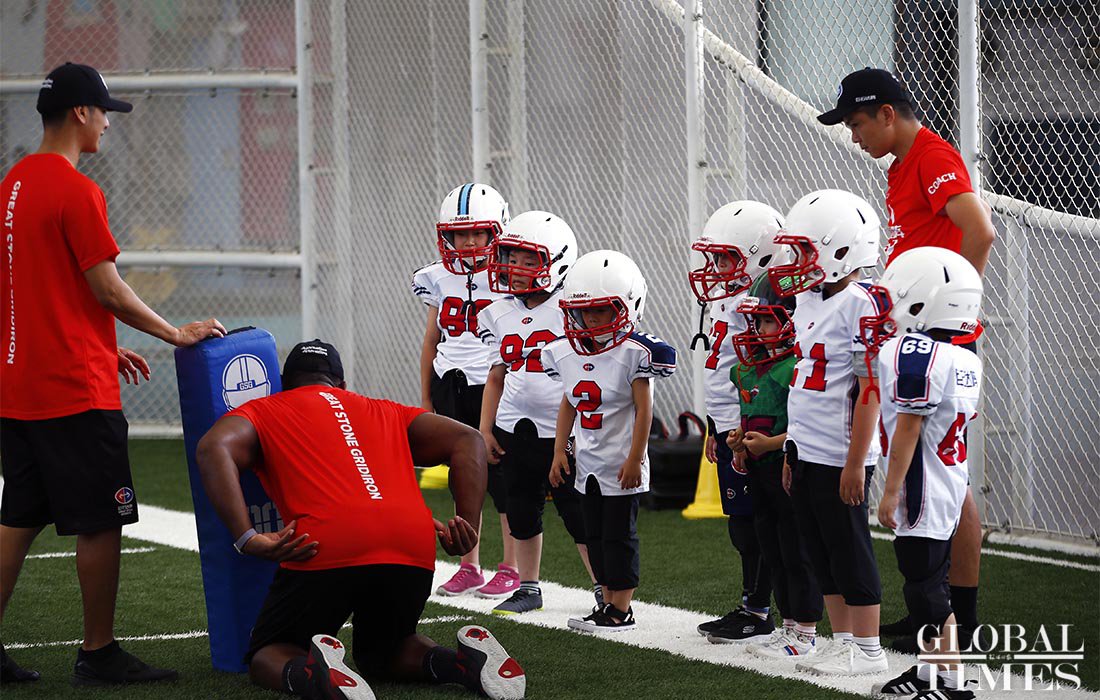 Children revel their summer vacation days with American football ...
