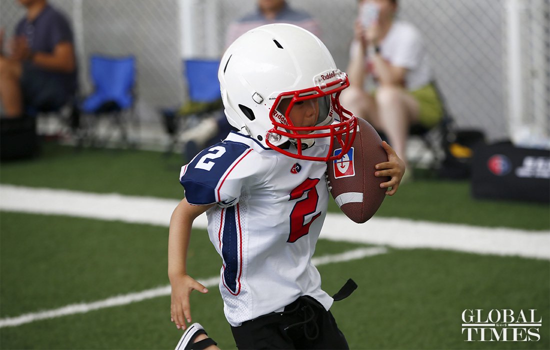 Children revel their summer vacation days with American football ...