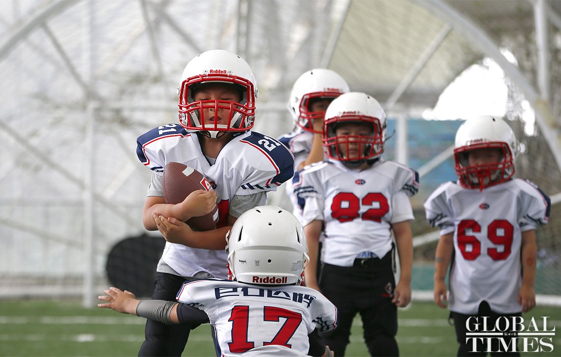 Children revel their summer vacation days with American football ...