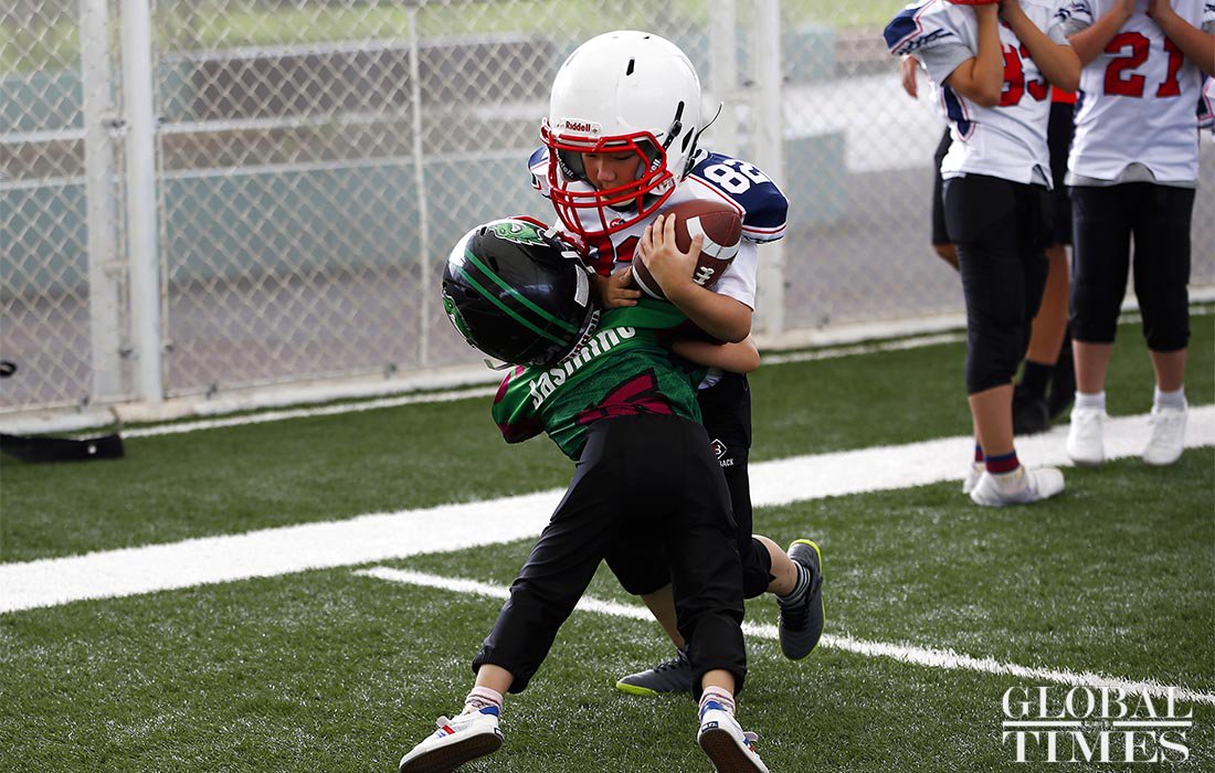 Children revel their summer vacation days with American football ...