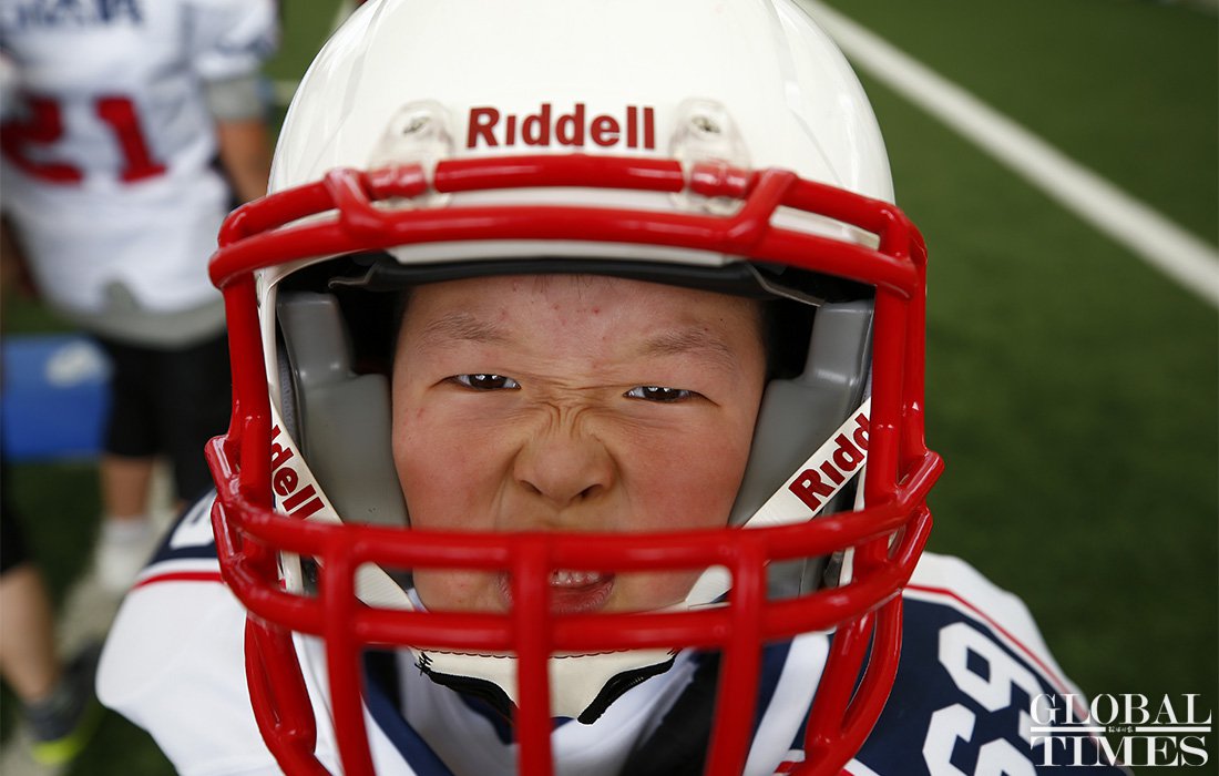 Children revel their summer vacation days with American football ...