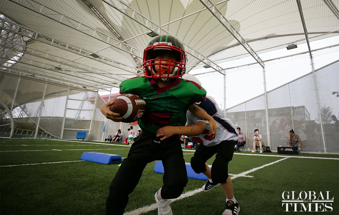 Children revel their summer vacation days with American football ...