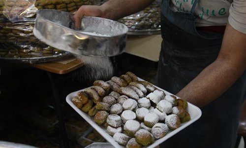 Palestinian vendor prepares traditional cookies for Eid al-Adha in ...