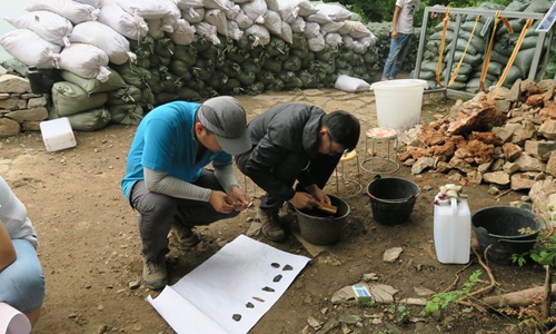 Over 200 relics unearthed in north China's Paleolithic cave site ...