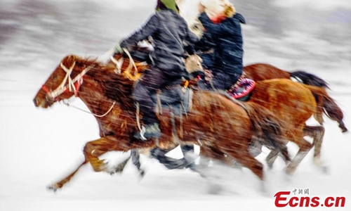 Tens of thousands of horses gallop on snowy grassland in northwest ...