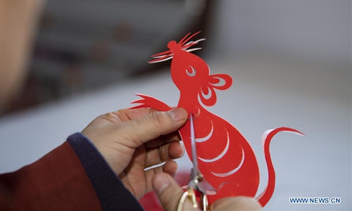 Artist inherits, develops paper-cutting skills for over 40 years in ...