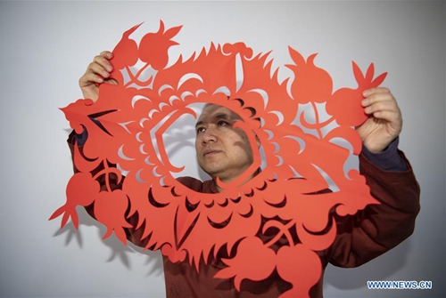 Artist inherits, develops paper-cutting skills for over 40 years in ...