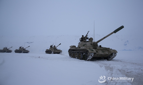 Armored vehicles rumble on snow-covered road - Global Times