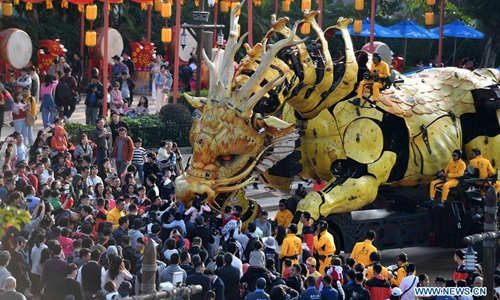 People watch mechanical Horse Dragon Long Ma in Zhuhai, S China ...