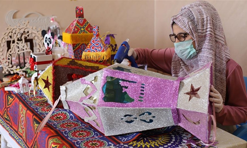 People wear protective mask to prepare ornaments for Islamic holy month ...