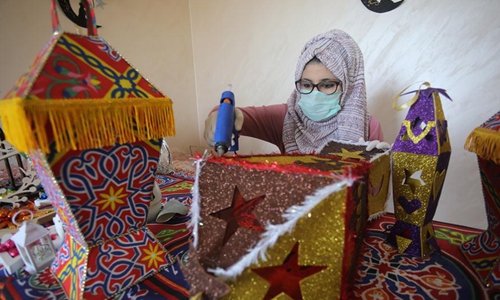 People wear protective mask to prepare ornaments for Islamic holy month ...