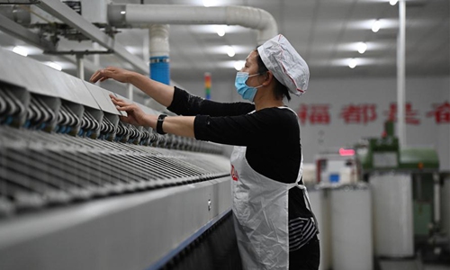 Staff members work at textile company in Henan - Global Times