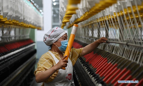 Staff members work at textile company in Henan - Global Times