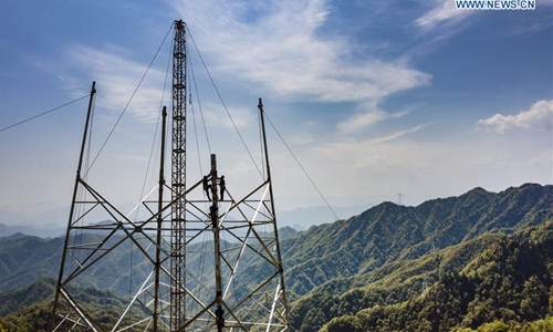 Electricians work at construction site of ultra-high voltage direct ...