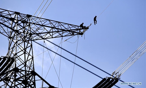 Workers install overhead power lines in Zhen'an, Shaanxi - Global Times