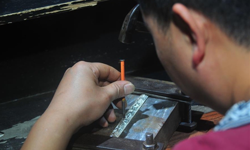 Miao silver forging skill taught in training institute in Hunan, C ...