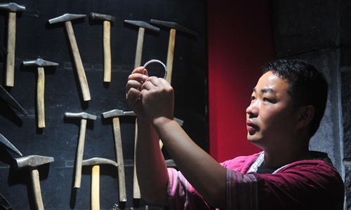 Miao silver forging skill taught in training institute in Hunan, C ...