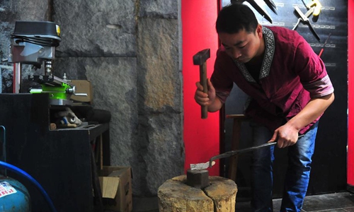 Miao silver forging skill taught in training institute in Hunan, C ...