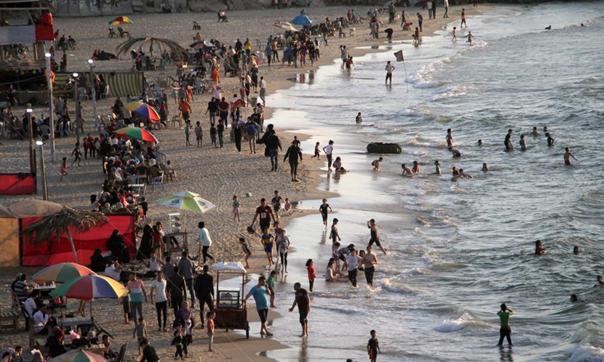 Palestinians enjoy their time during sunset at seaside in Gaza City ...